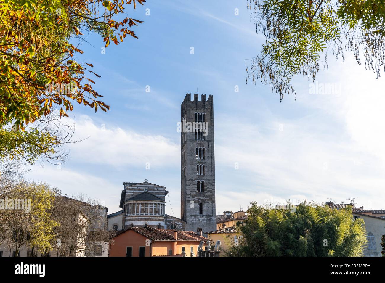 Downtown Lucca in Tuscany framed by autumn foliage with a view of the ...