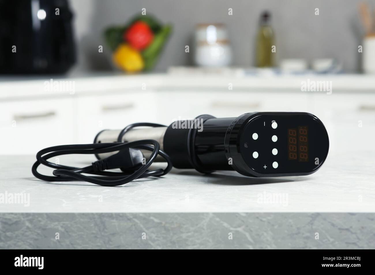 Thermal immersion circulator on table in kitchen. Sous vide cooking ...