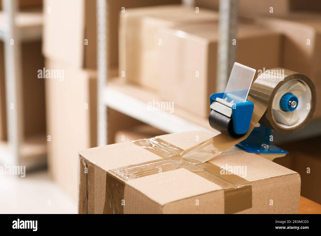 Taping box with adhesive tape dispenser indoors. Space for text Stock ...