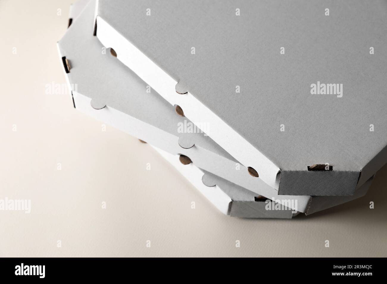 Stack of empty pizza boxes on beige background, closeup Stock Photo - Alamy