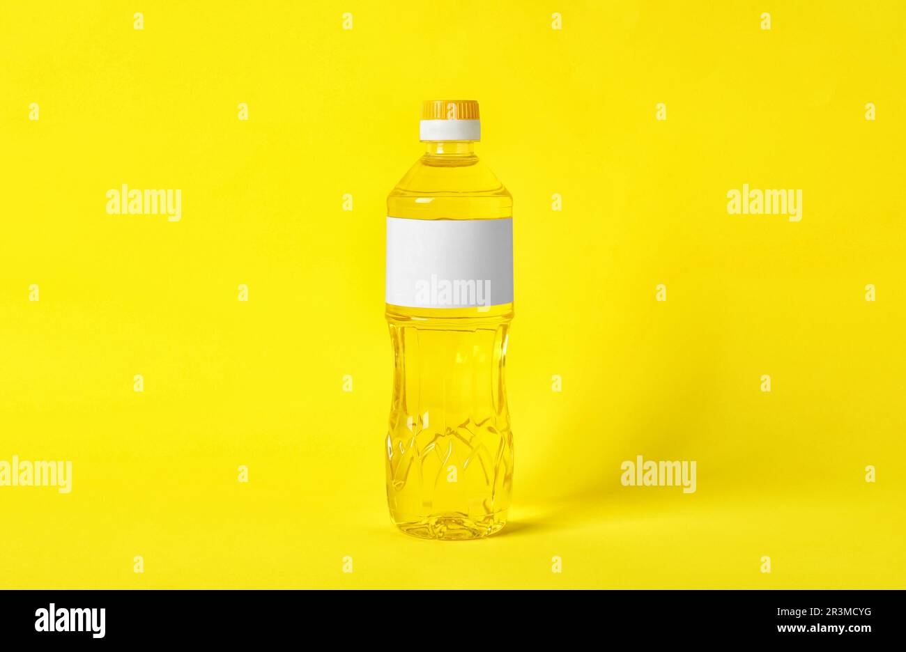 Bottle of cooking oil on yellow background Stock Photo - Alamy