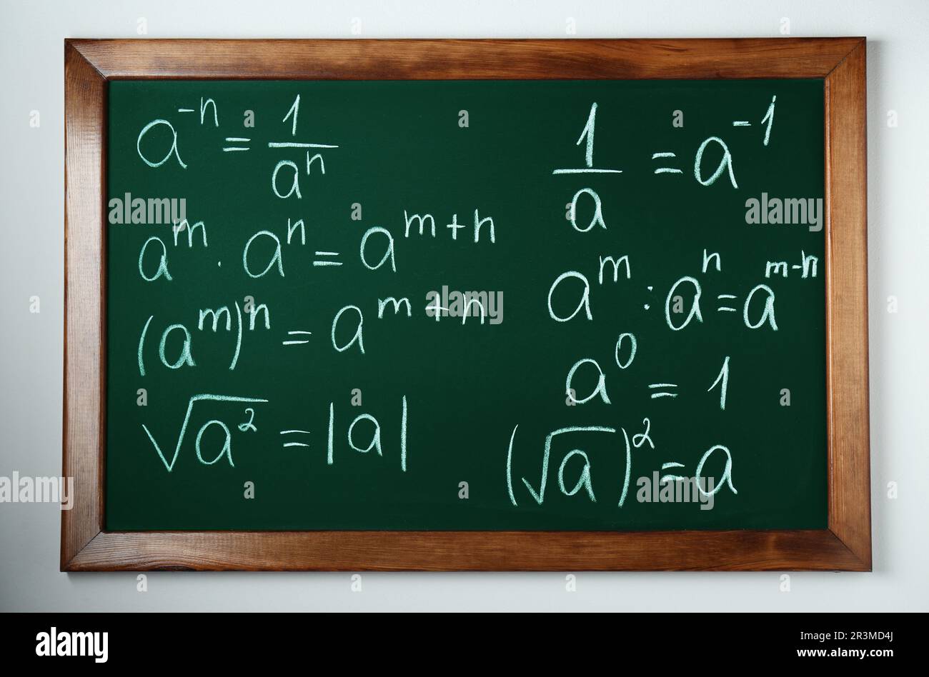 Chalkboard with many different math formulas on white wall Stock Photo ...