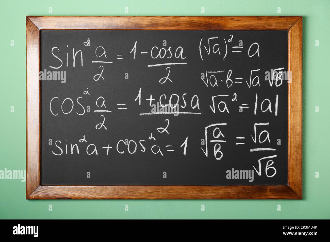 Chalkboard with many different math formulas on green wall Stock Photo ...