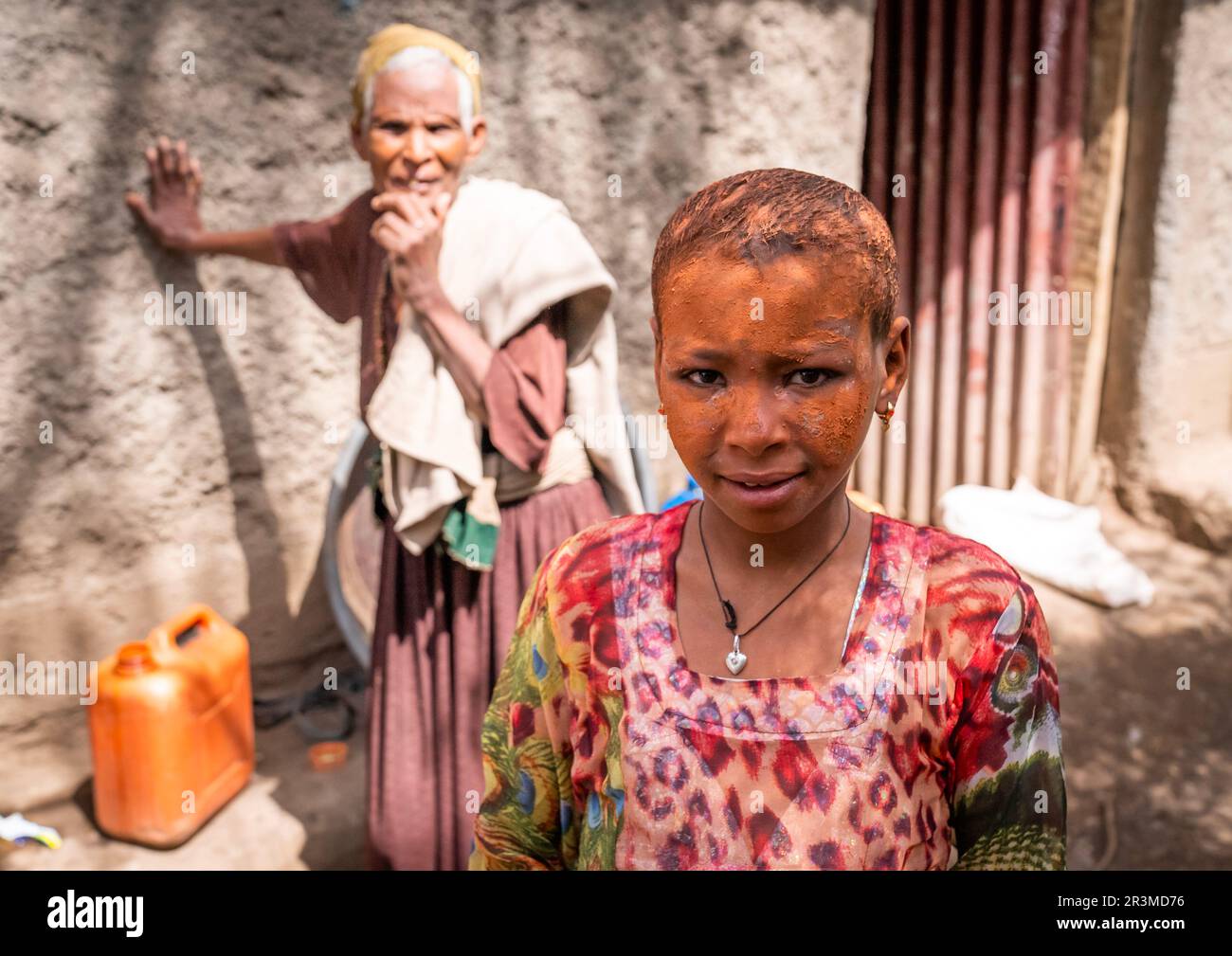 Ethiopian girl with face covered by holy soil in Bilbaia Giorgis rock ...