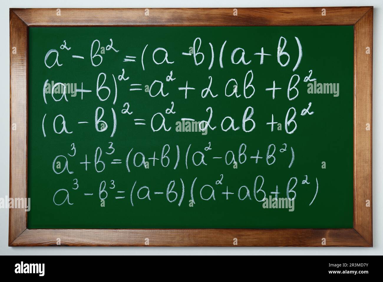 Chalkboard with many different math formulas on white wall Stock Photo ...