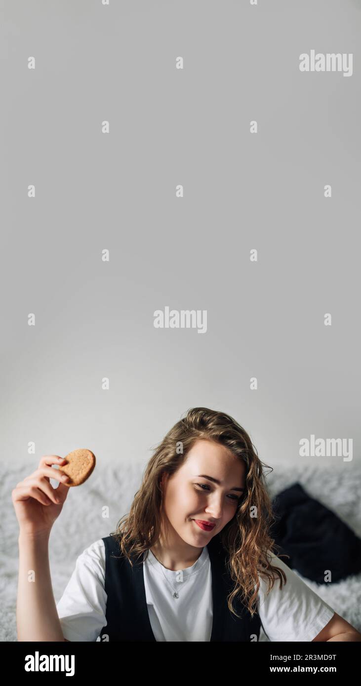 Happy Young Woman Multitasking with TV and Snacks, Relaxing Home ...