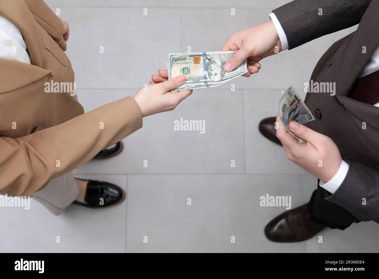 Man giving money to woman indoors, above view. Currency exchange Stock ...