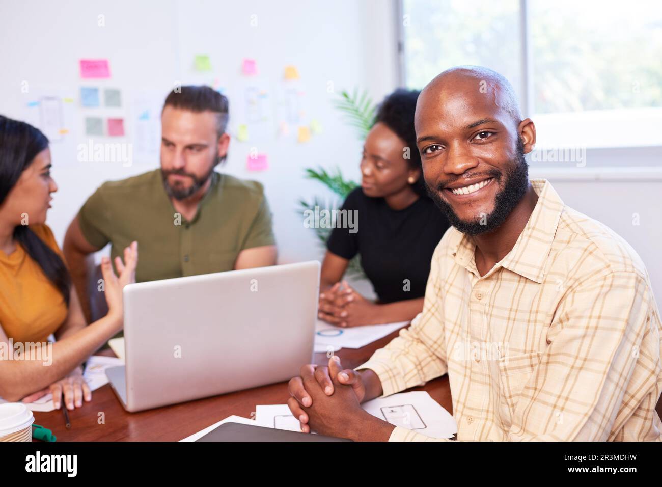 Portrait of smiling Black man, development team, mobile app coding ...