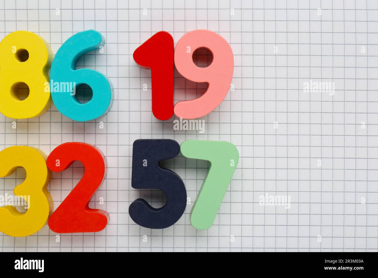 Colorful numbers on sheet of grid paper, flat lay. Space for text Stock ...