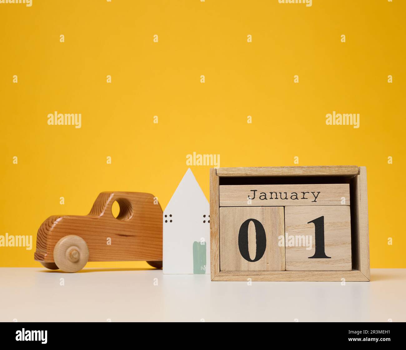 Wooden calendar made of cubes on a yellow background. Date January 1st ...