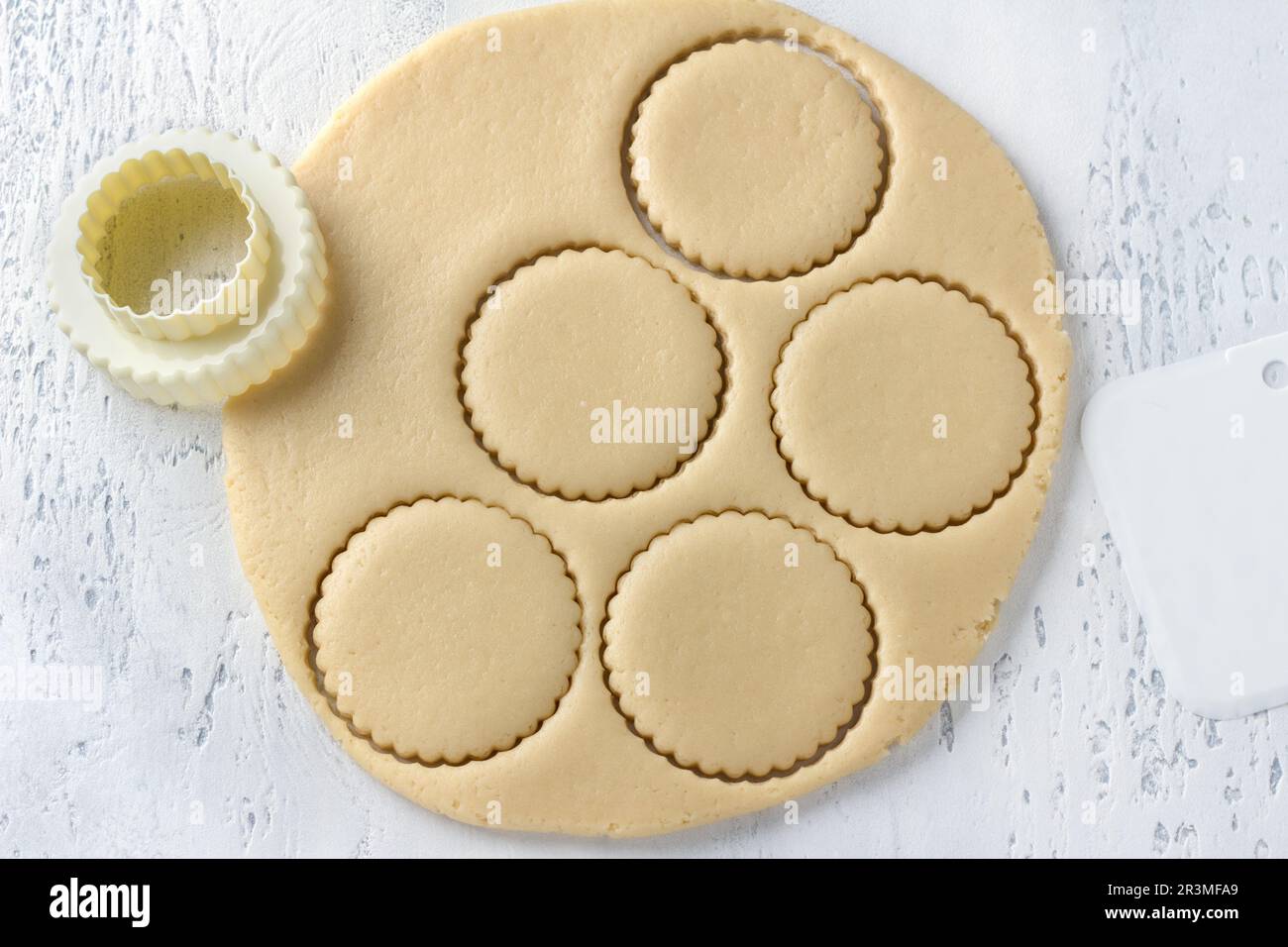 The process of cutting cottage cheese cookies with molds from soft ...