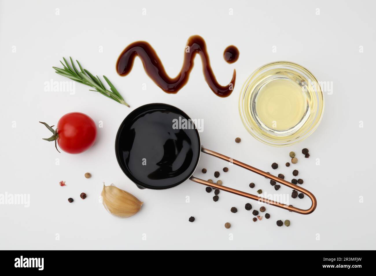 Organic balsamic vinegar and cooking ingredients on white background ...