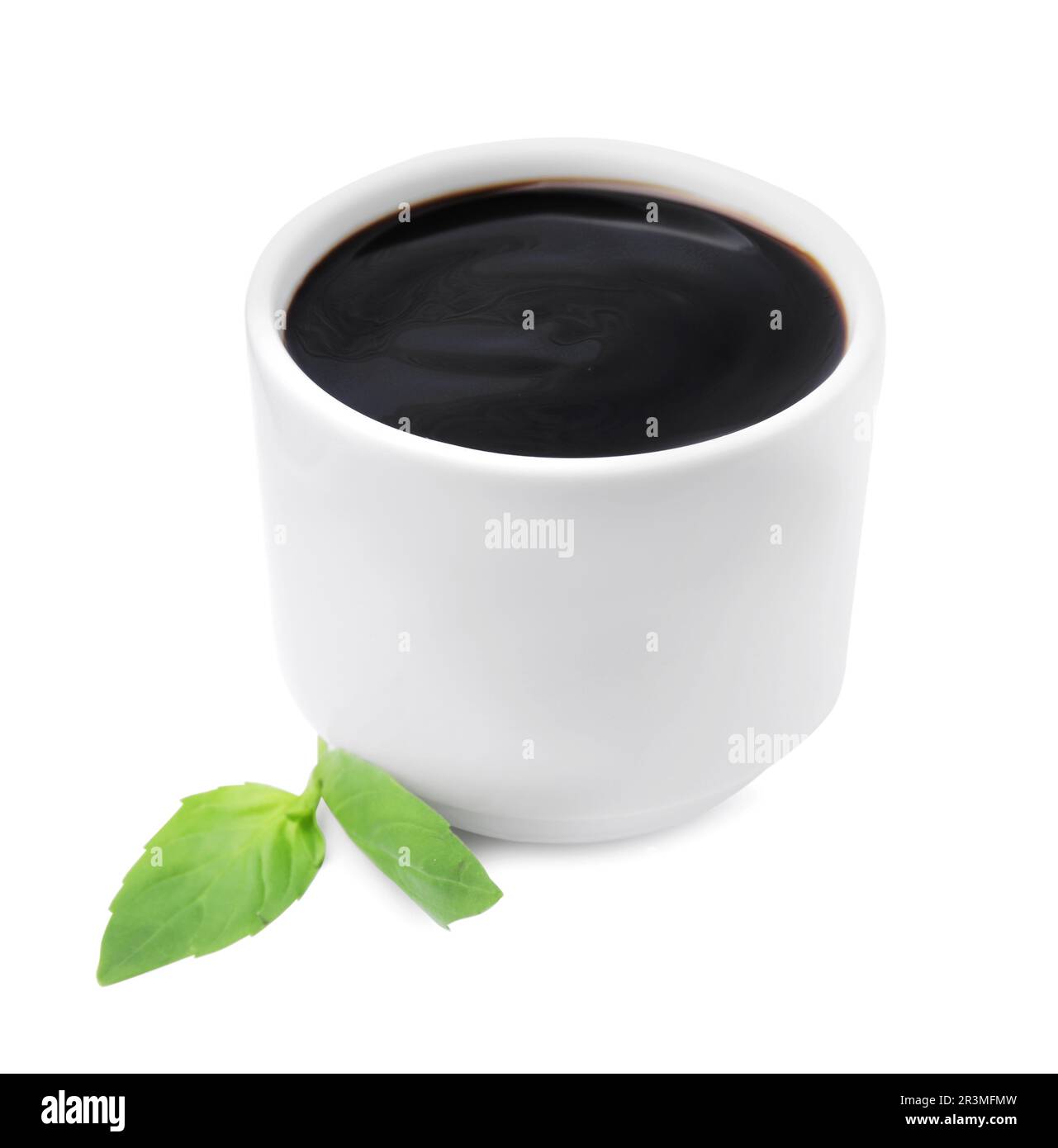 Balsamic glaze and basil leaves on white background Stock Photo - Alamy