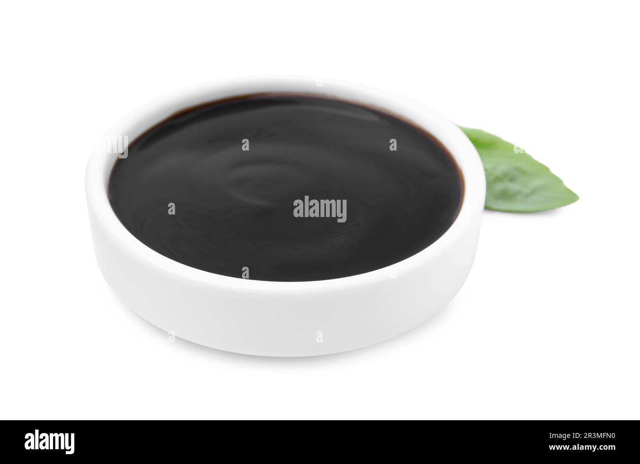 Balsamic glaze and basil leaf on white background Stock Photo - Alamy