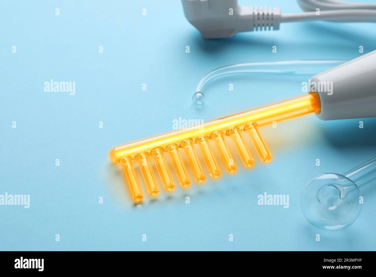 Working high frequency darsonval device with nozzles on light blue ...