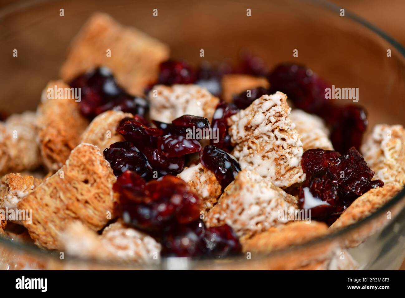 Breakfast cereal with dried cranberries in a glass bowl Stock Photo - Alamy
