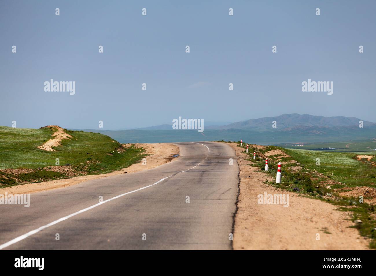Empty road running through the steppes of Mongolia in the Bulgan ...