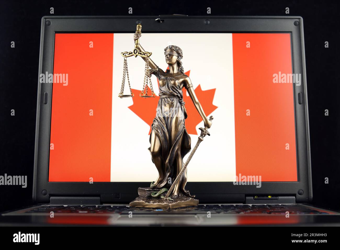 Symbol of law and justice with Canada Flag on laptop. Studio shot Stock ...
