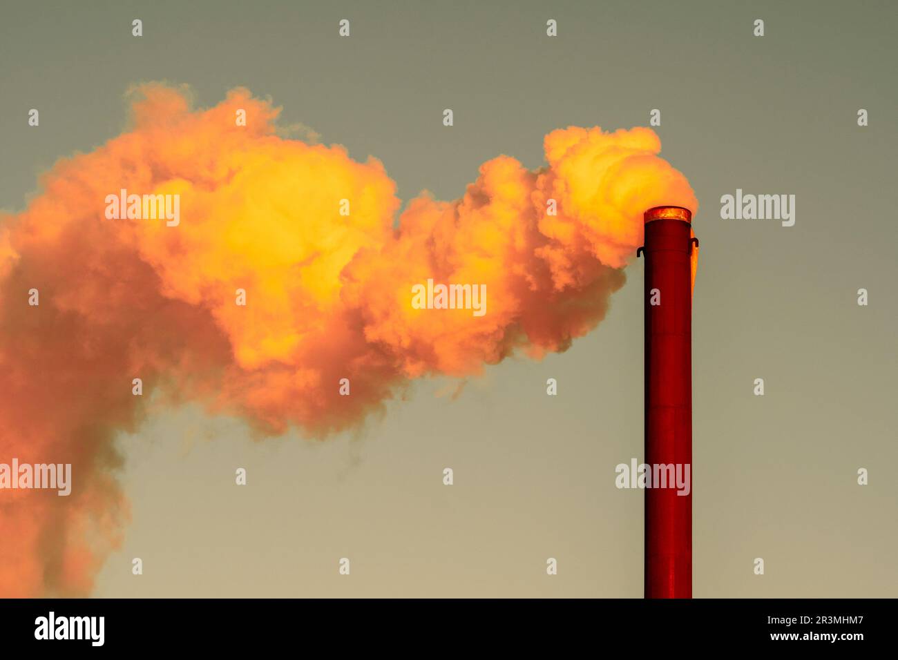 Thick and toxic smoke coming out of a chemical factory chimney under a ...