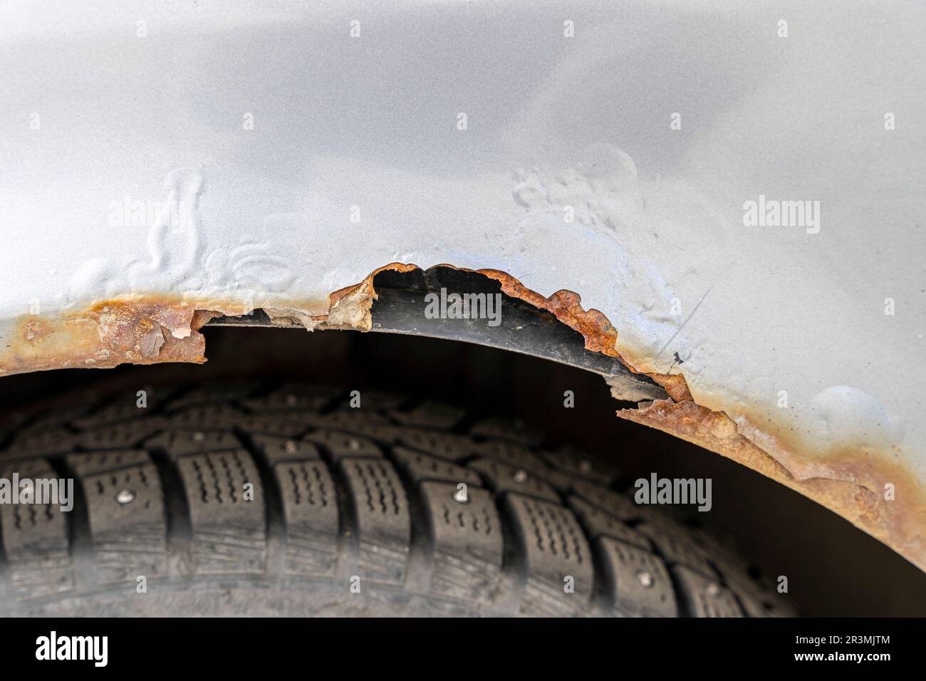 rusty fender of the car. a rusty hole on an old car Stock Photo - Alamy