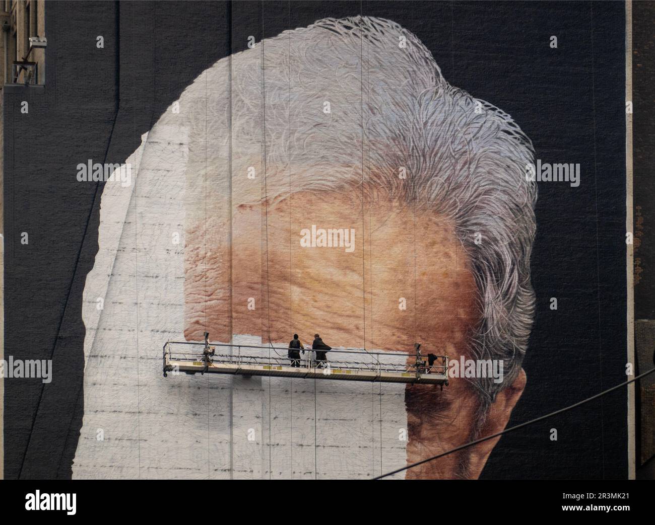 Hanging a billboard mural ad advertising painting large giant face hi ...