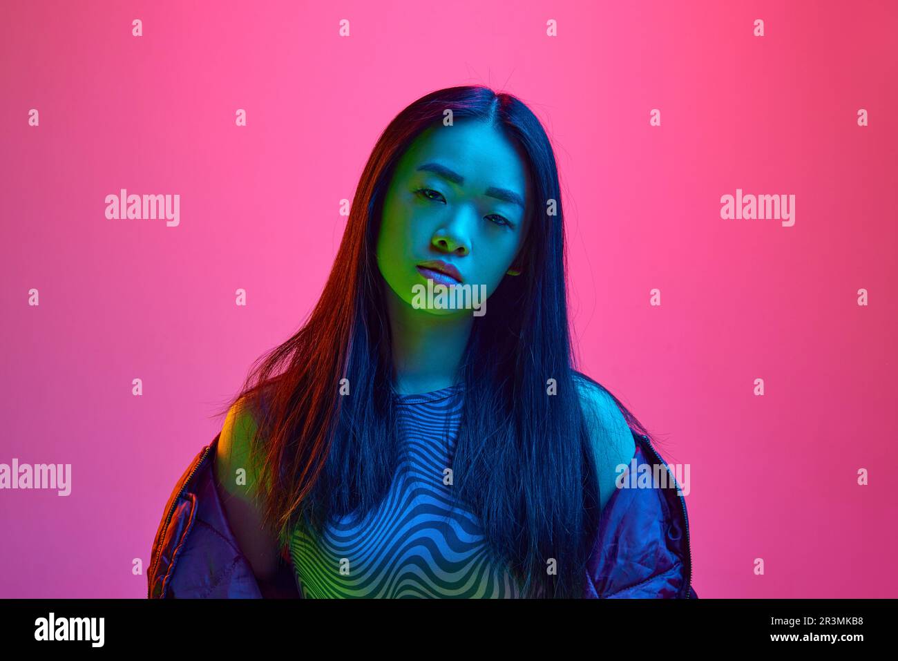 Portrait of young, beautiful, korean girl looking at camera with ...