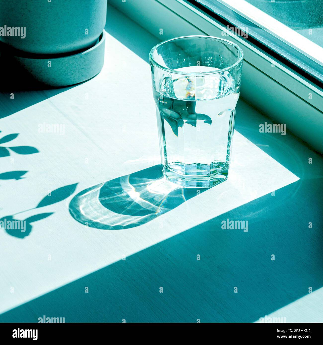 A glass of pure spring water and sharp shadows Stock Photo - Alamy