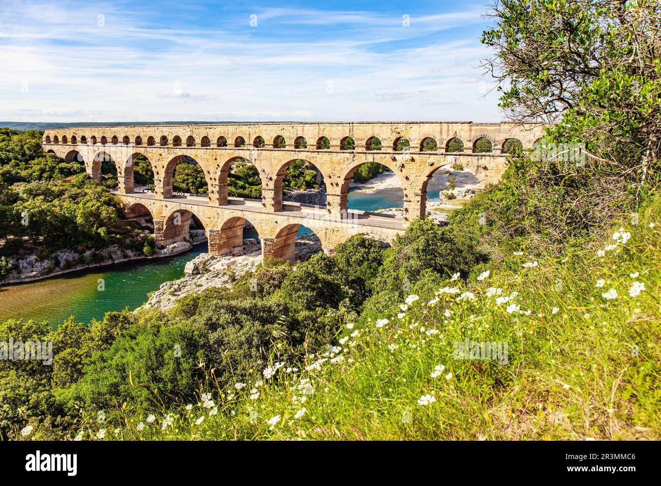 The aqueduct Pont du Gard is a three-tiered arcade. The shallow Gardon ...