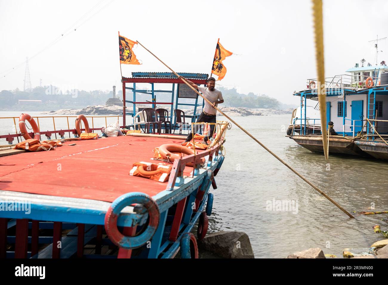 Local working as a shipman on a Traditional wooden passenger boat on a ...