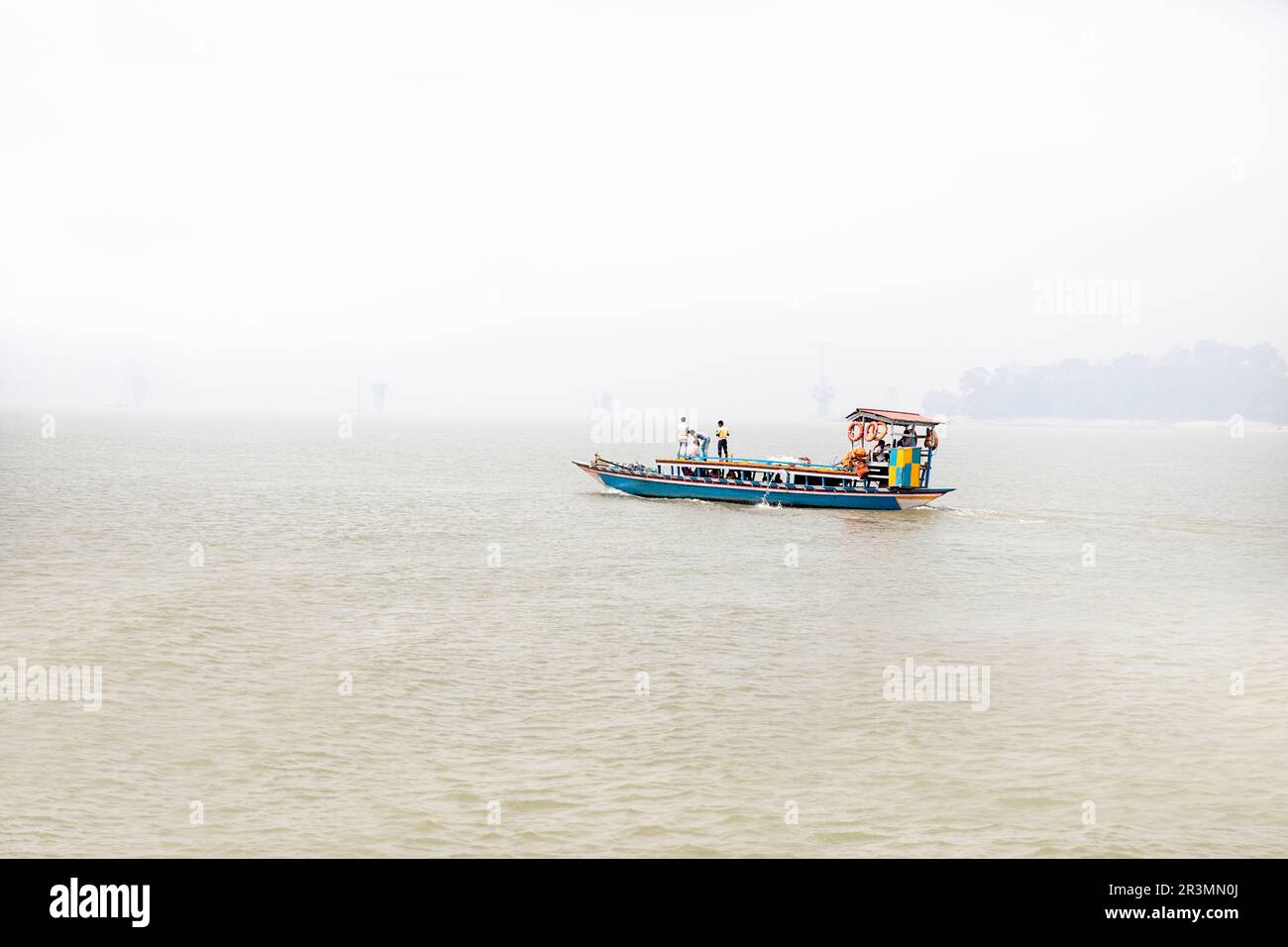 Local traditional wooden boat sailing in the middle of river ...