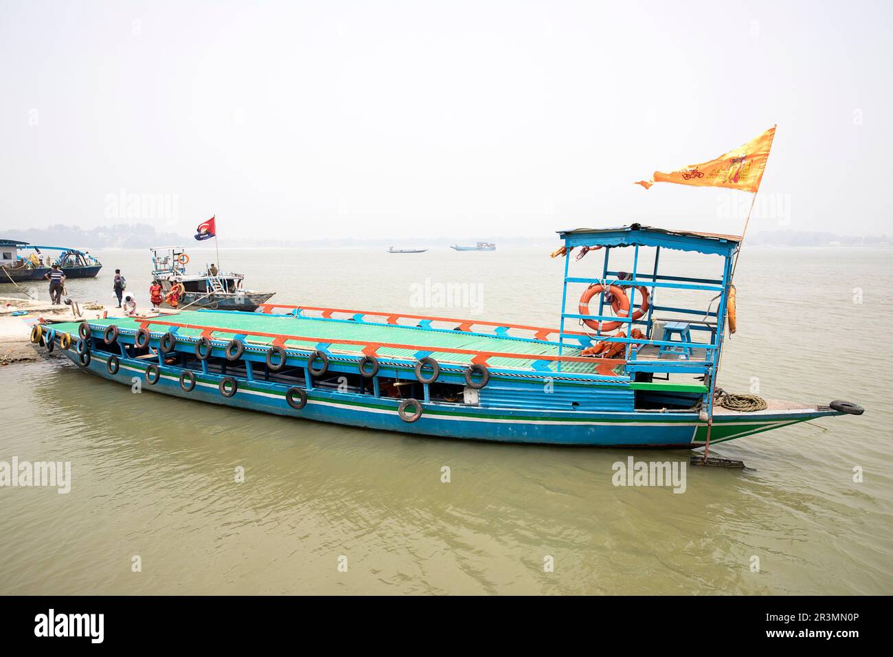 Local traditional wooden boat docked on river Brahmaputra near Guwahati ...