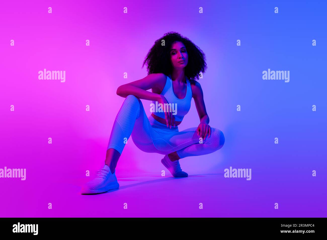 Full body photo of cool fitness blogger squat advertise trendy outfit ...