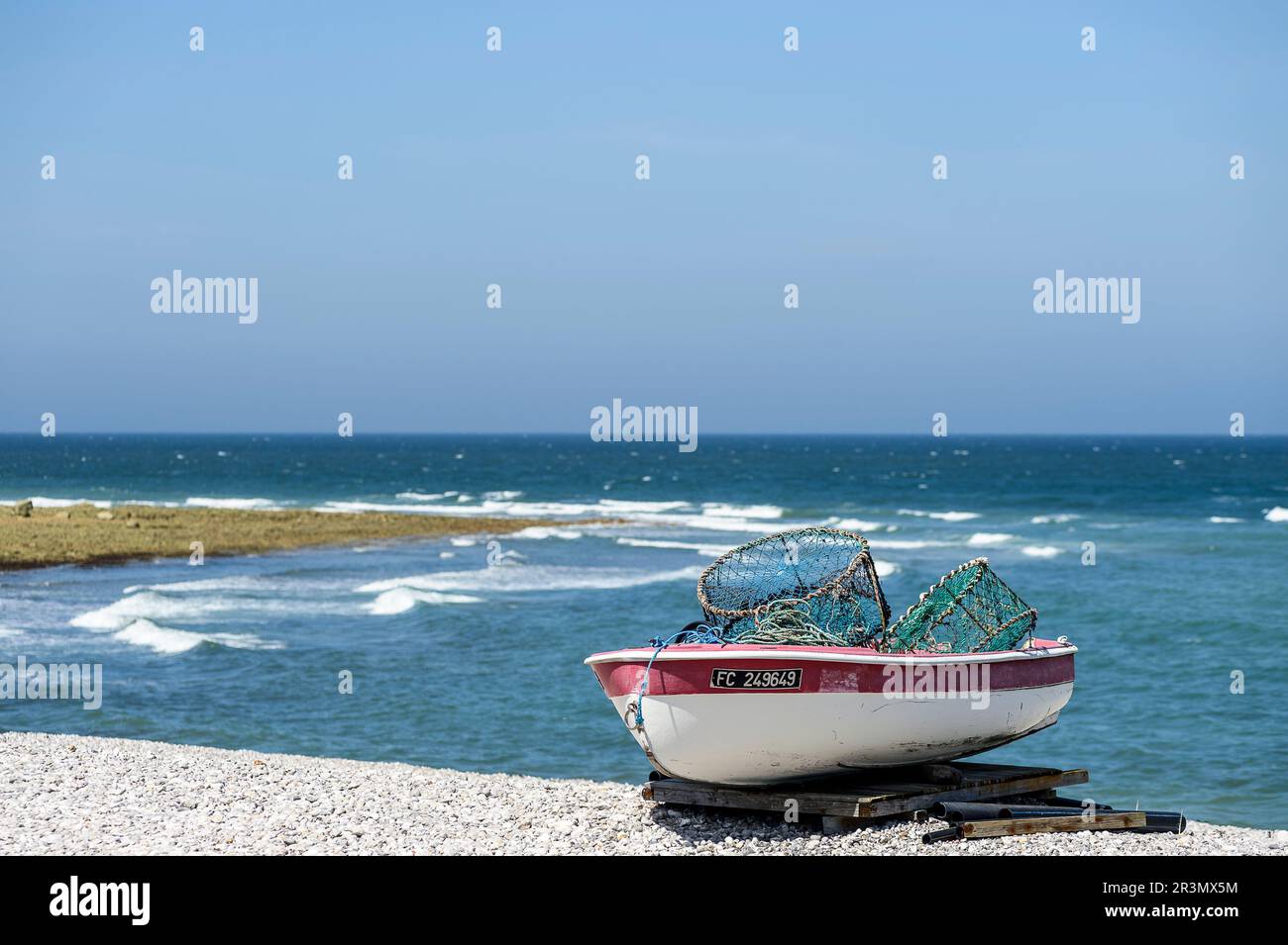 Yport, the pebbles beach, the small boat and the cliffs in front of the ...