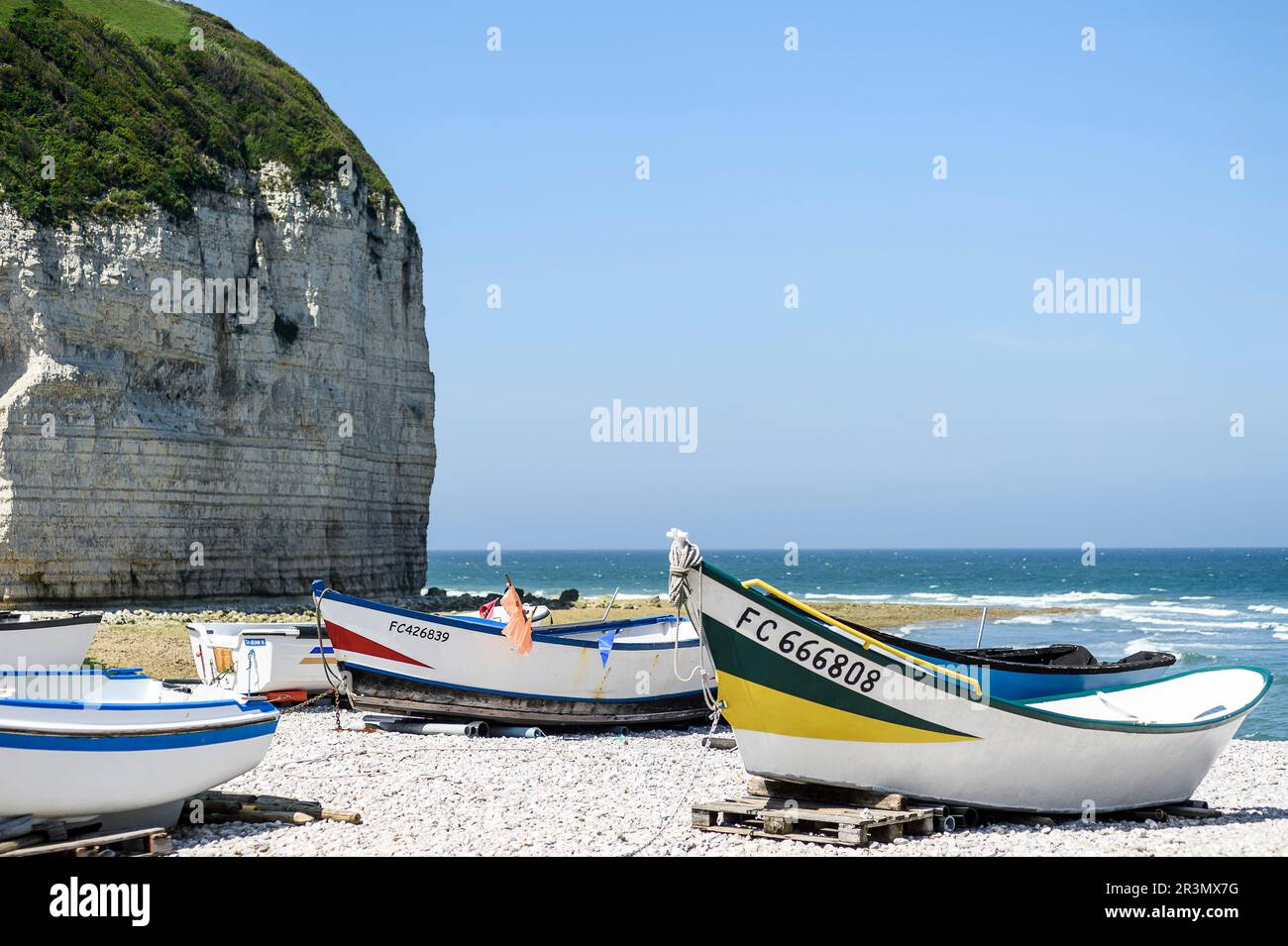 Yport, the pebbles beach, the small boat and the cliffs in front of the ...