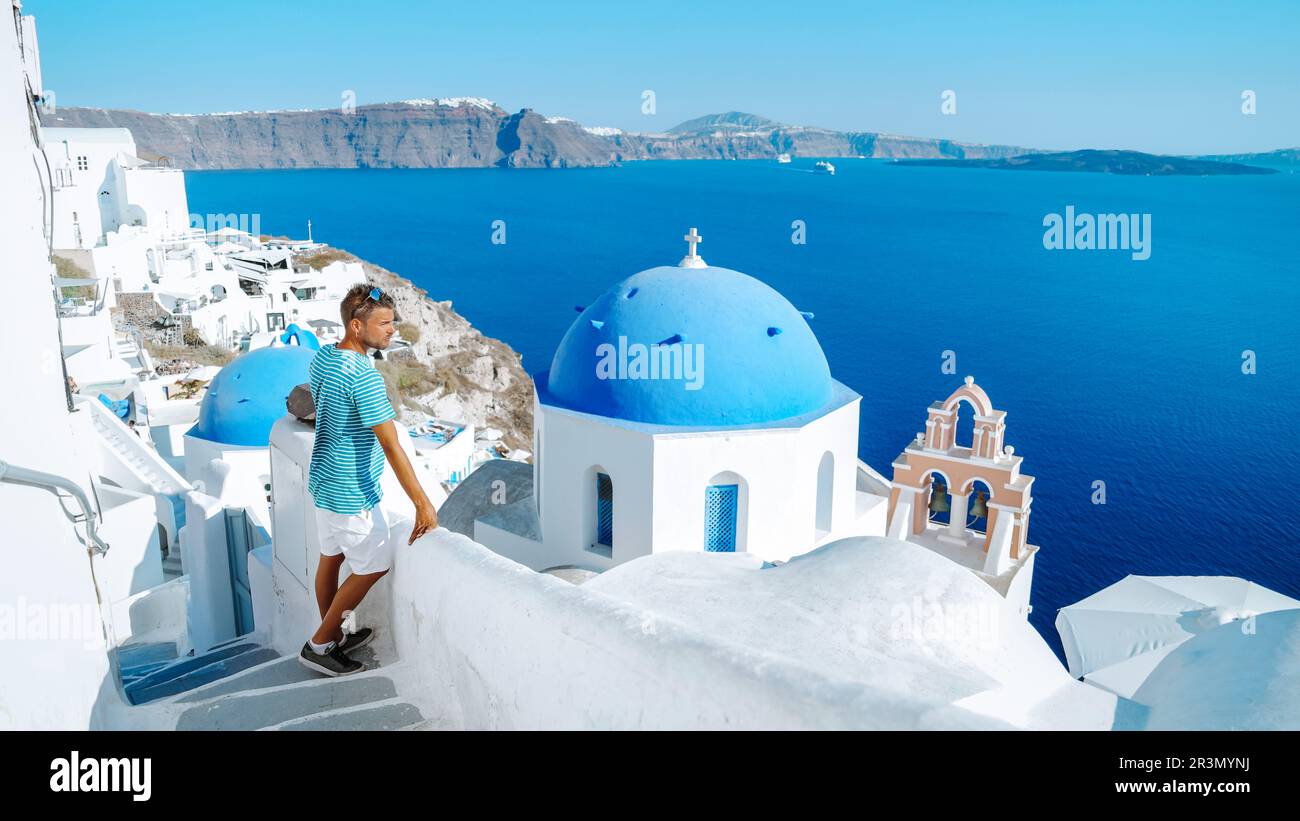 Santorini Greece, young men on vacation at the Island of Greece ...