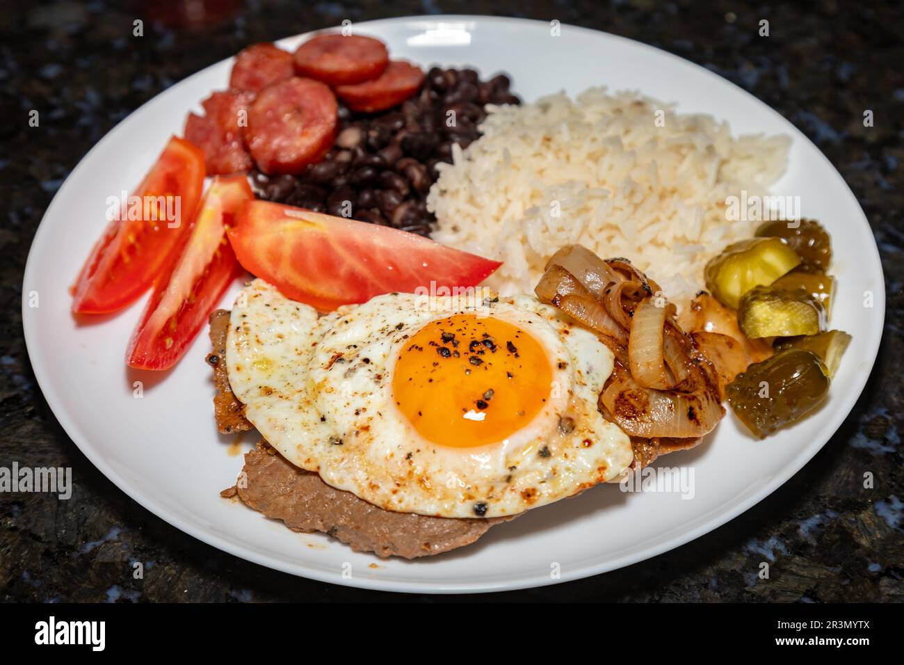 Traditional Brazilian daily meal, black beans, rice, meat, salad. real ...