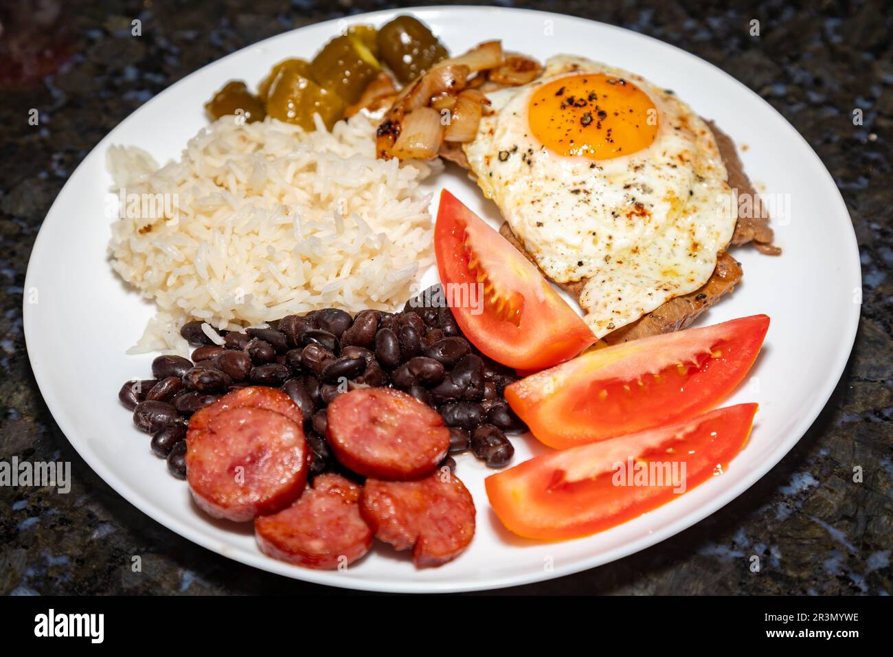 Traditional Brazilian daily meal, black beans, rice, meat, salad. real ...