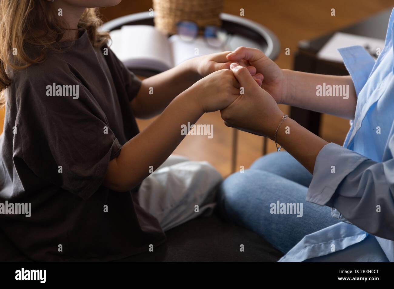 Adult and children's hands together, psychological assistance to the ...
