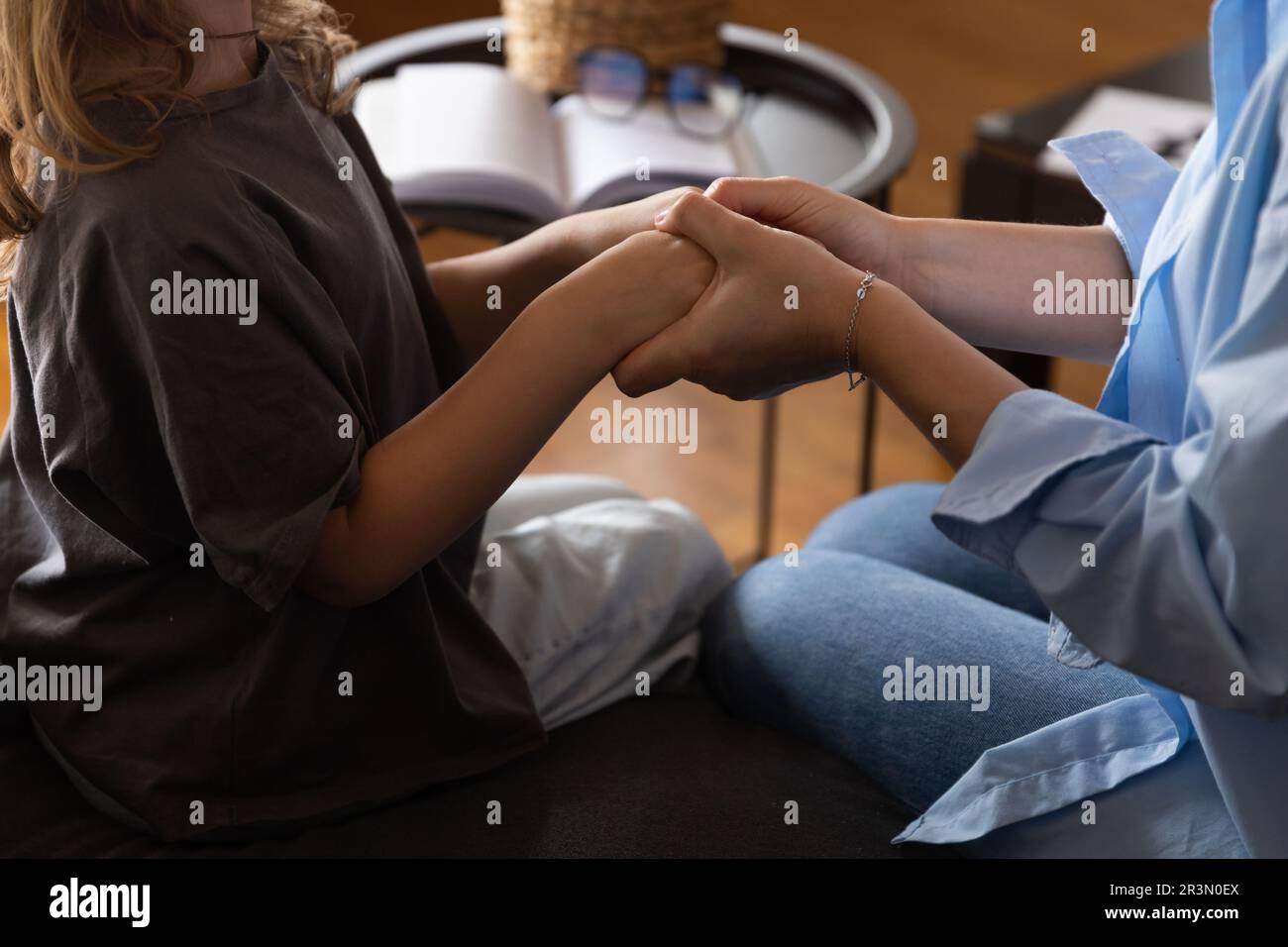 Adult and children's hands together, psychological assistance to the ...