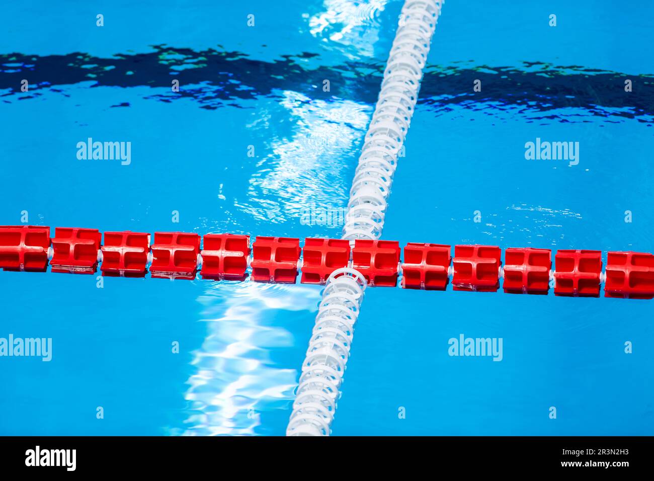 The view of an empty public swimming pool indoors. Lanes of a ...