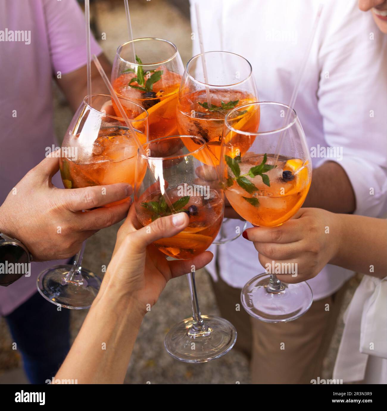 Happy friends spending time together, drinking Aperol spritz cocktail ...
