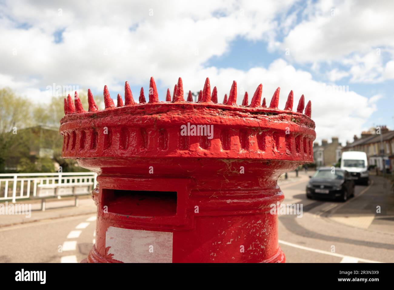 Strange pointed top on red letter post box riverside Cambridge England ...