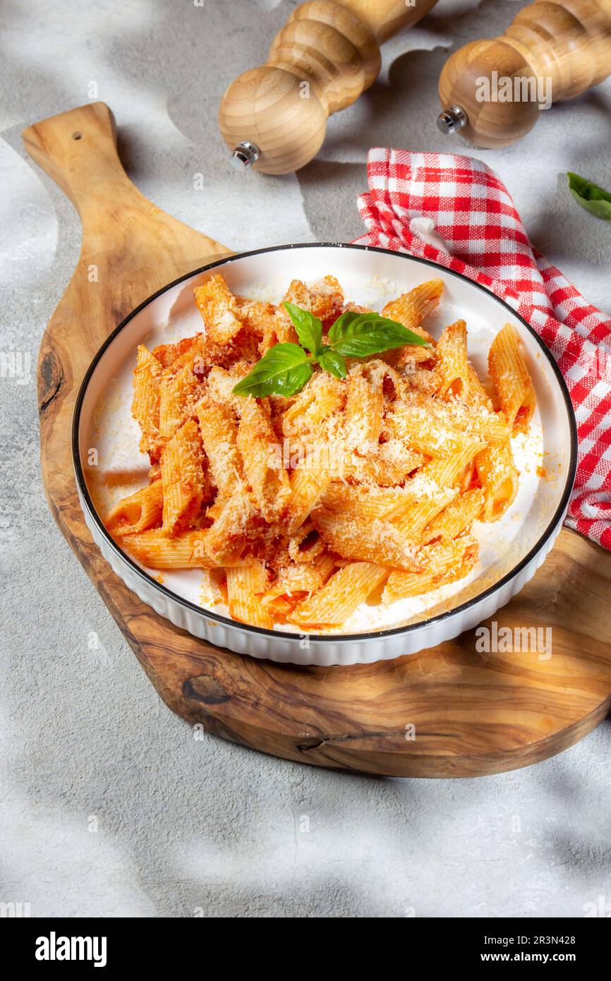 Pasta penne with tomato sauce and parmesan Stock Photo - Alamy