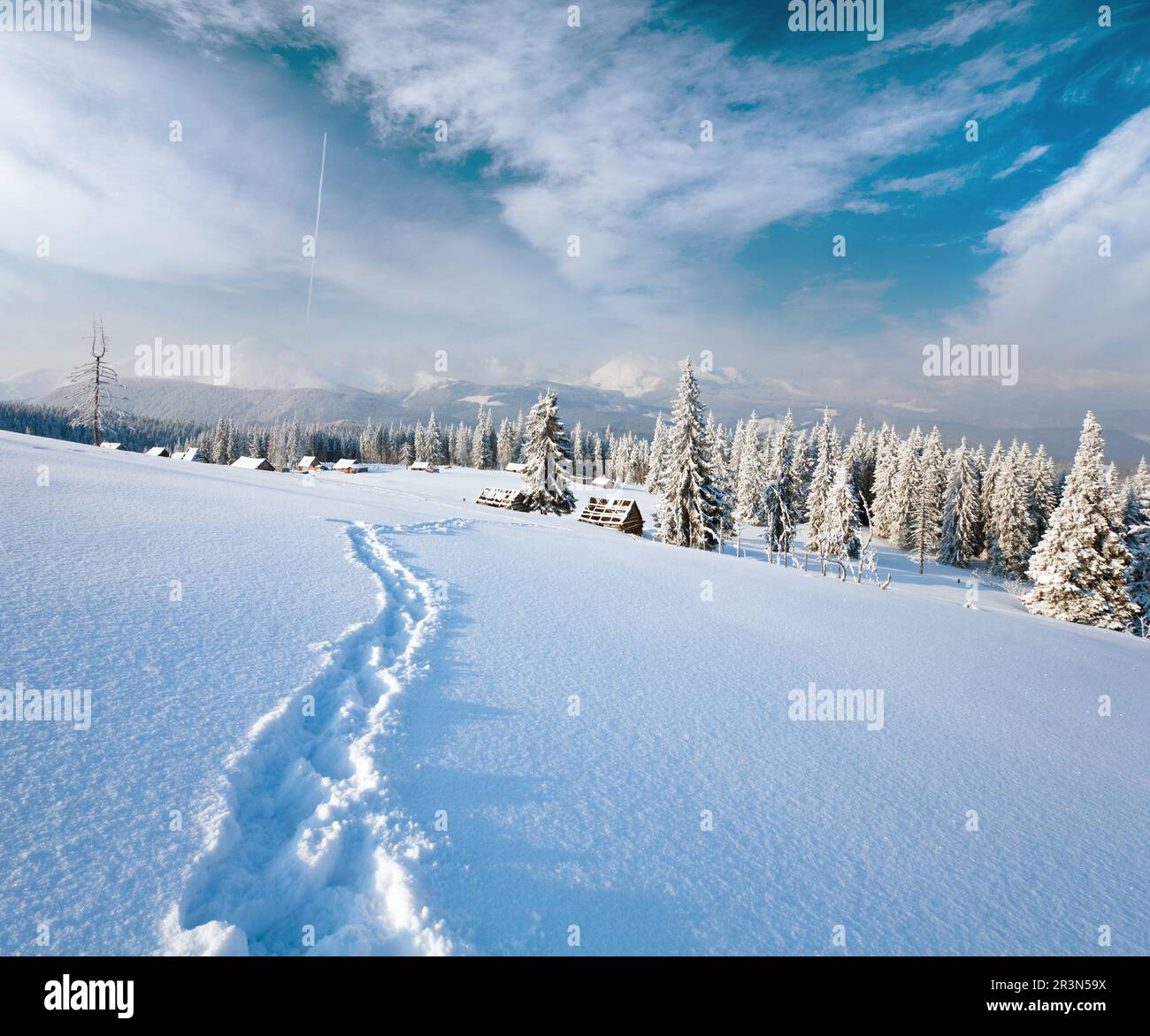 Winter calm mountain landscape with sheds group and mount ridge behind ...