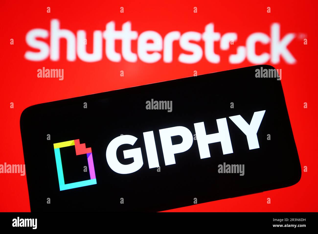 In this photo illustration, Giphy logo is seen on a smartphone and ...