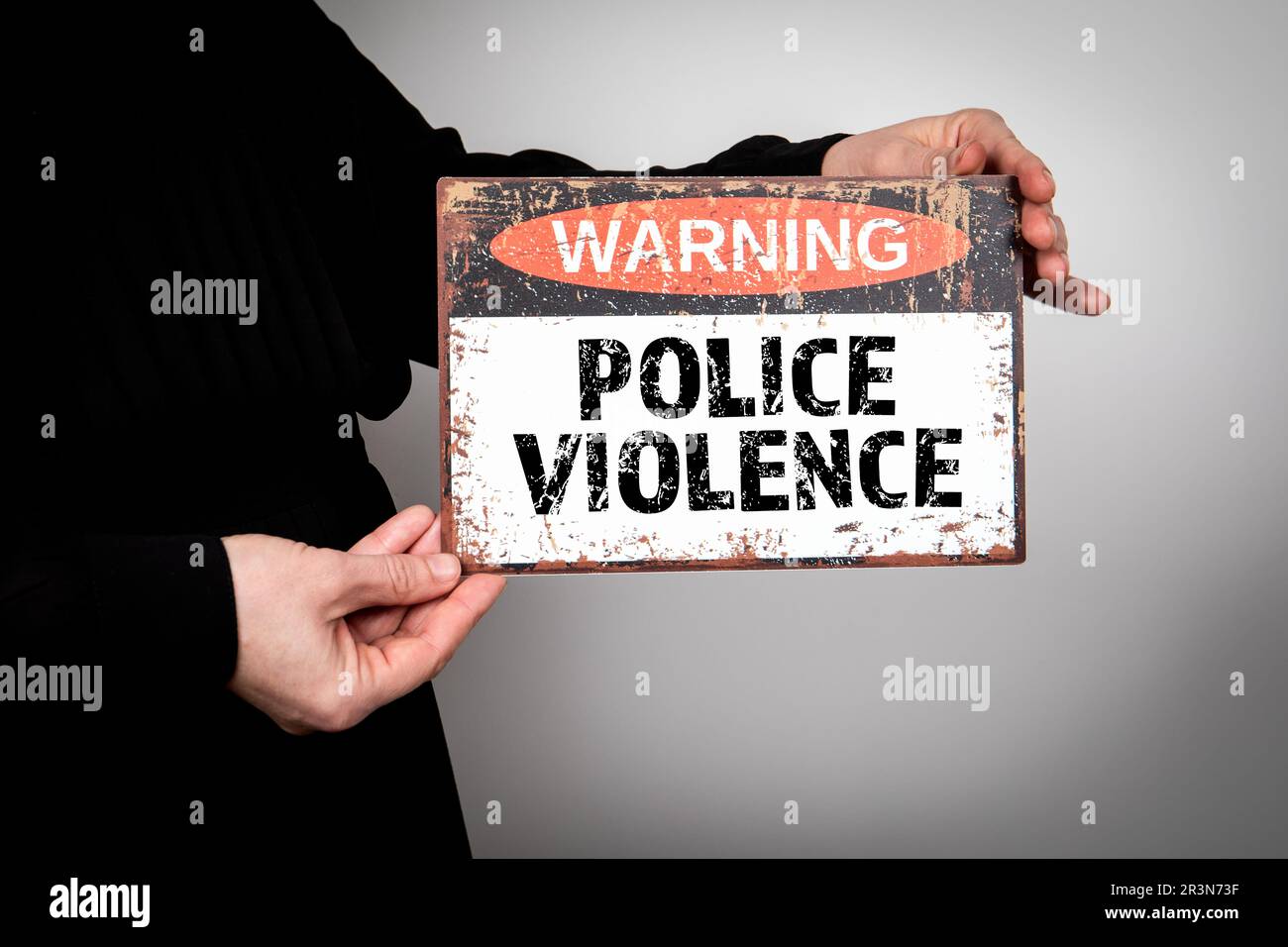 POLICE VIOLENCE. Warning sign in a woman's hand on a white background ...