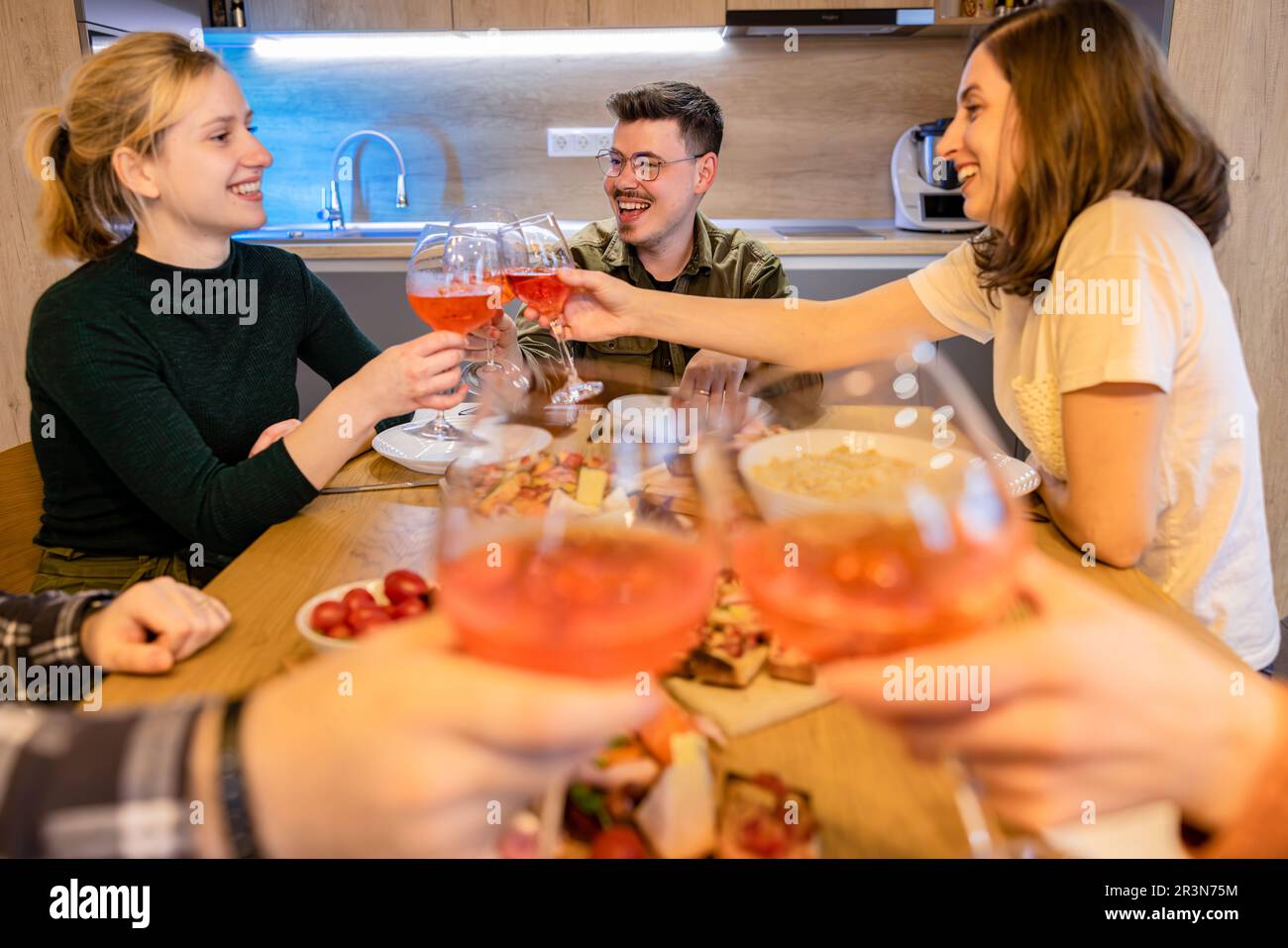 Glow faces of friends having a toast Stock Photo - Alamy