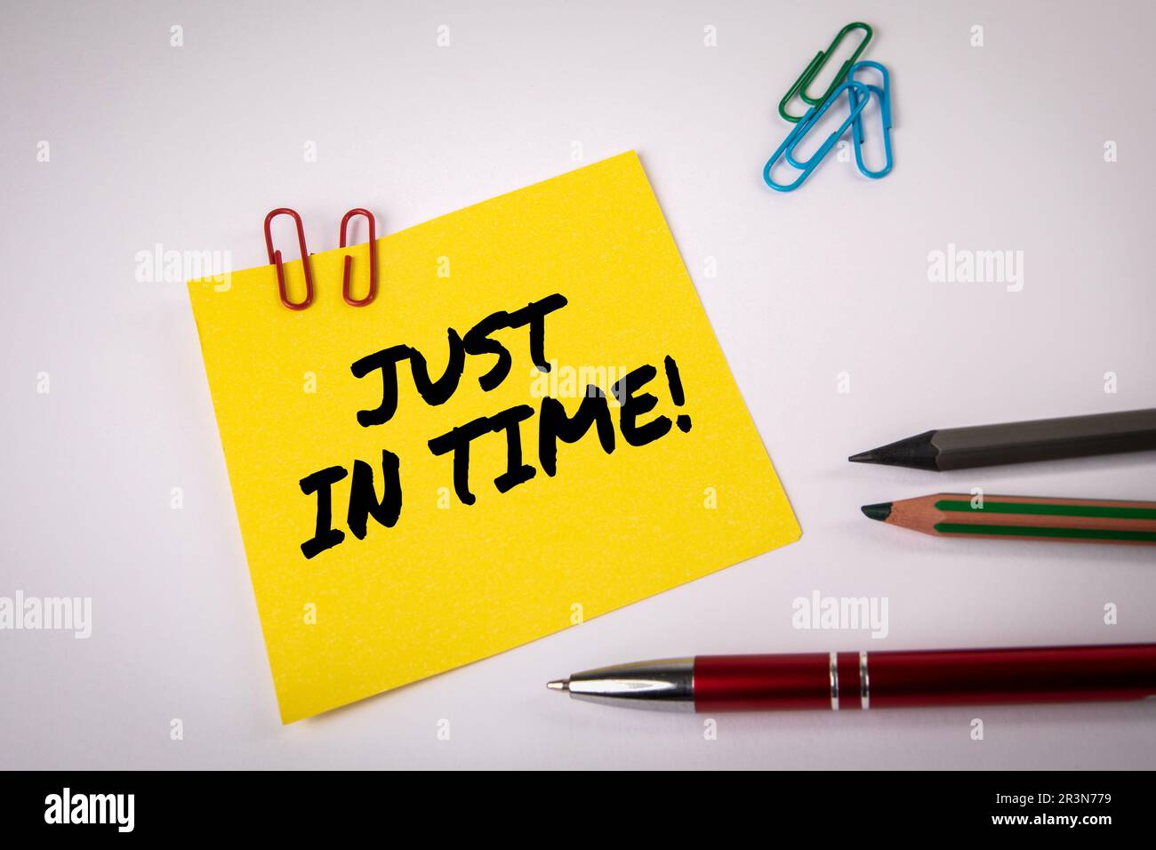Just In Time. Text on yellow notepad, white background Stock Photo - Alamy
