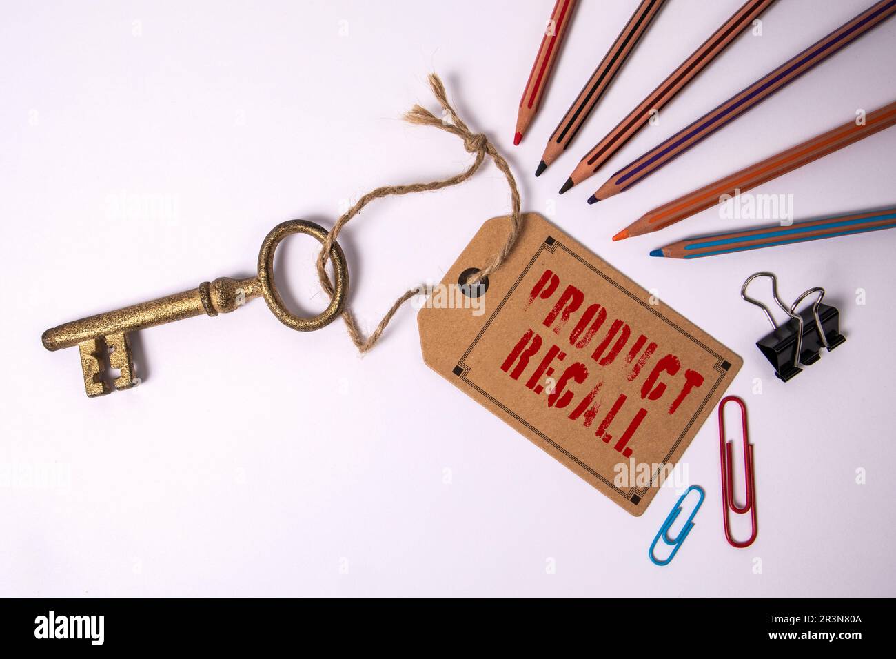 Product Recall Concept. Key with price tag, office supplies on white background Stock Photo - Alamy