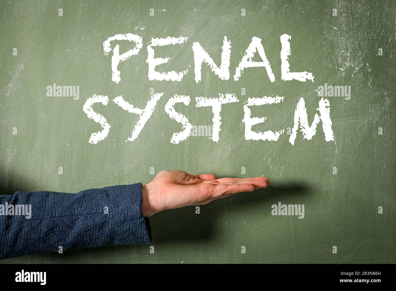 Penal System Concept. Text and a woman's hand on a green chalkboard ...